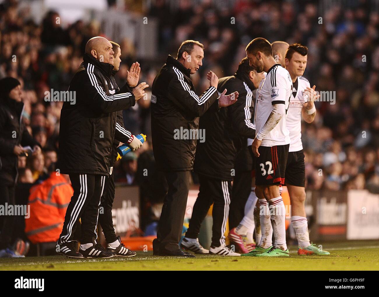 Fulham manager Rene Meulensteen (centre) gives instructions to Clint ...