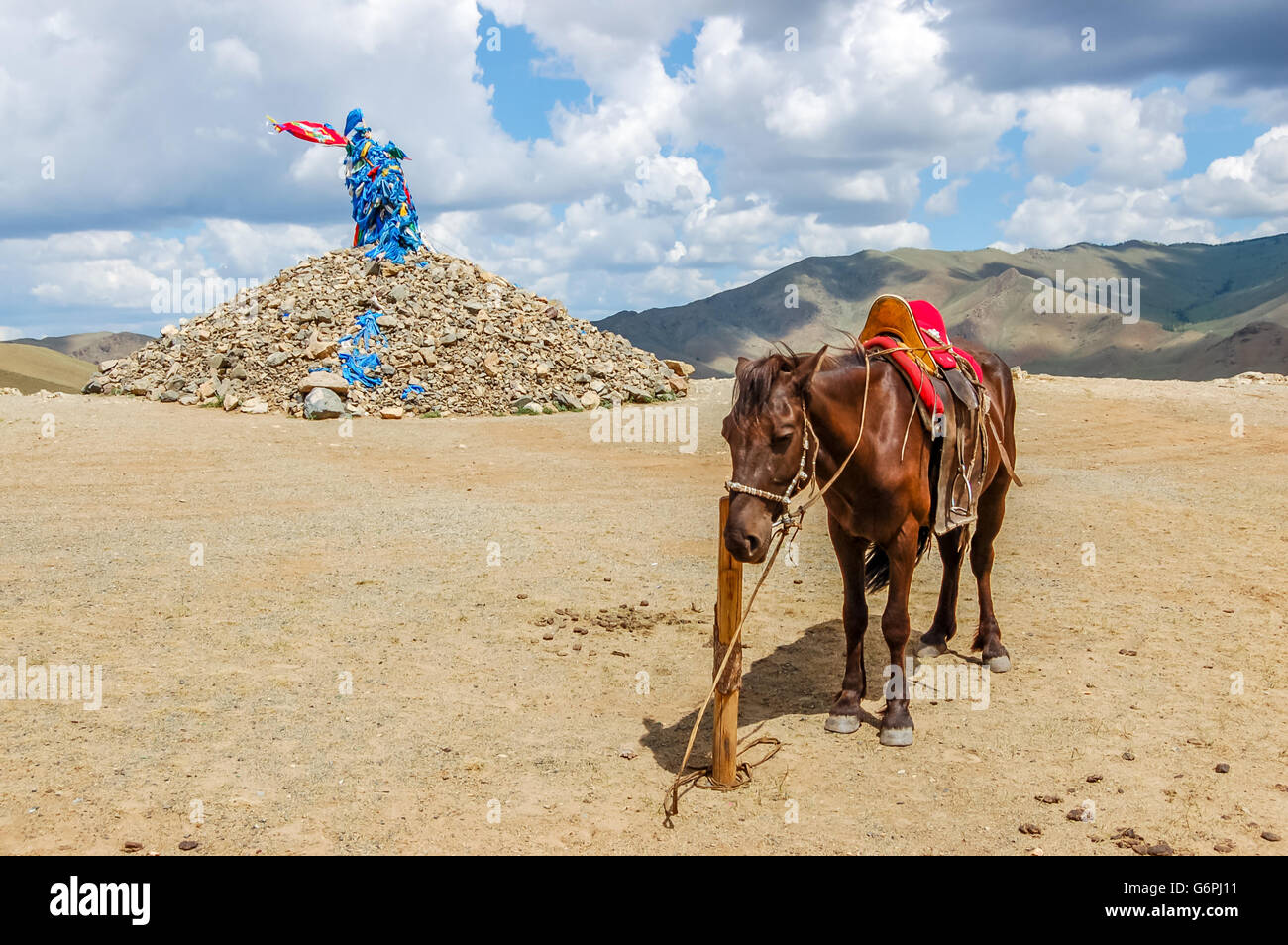 Horse & sacred cairn (ovoo) with prayer flags (khadag), central ...