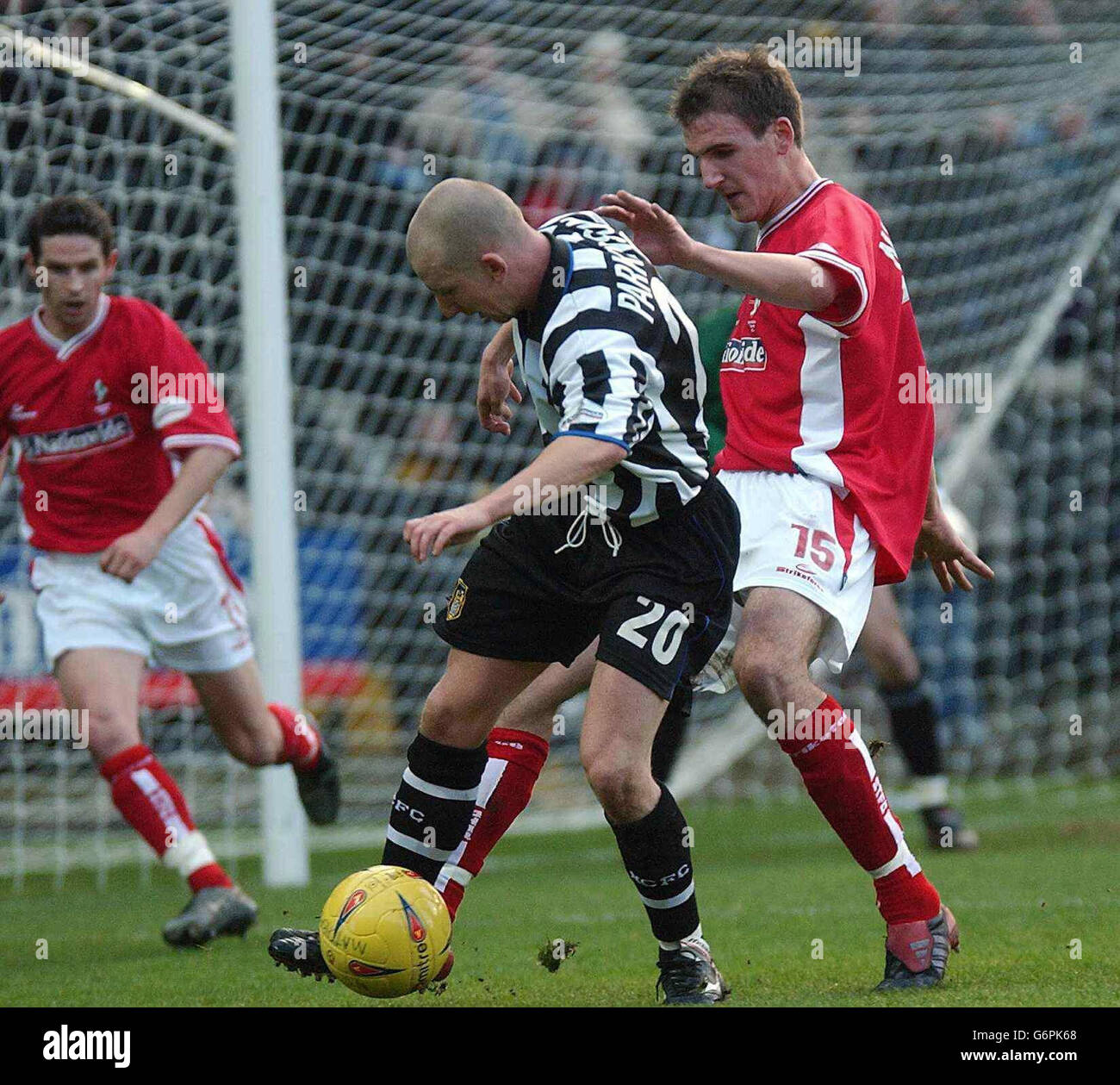 Swindon's Andy Nicholas trys to tackle Notts County's Andrew Parkinson ...