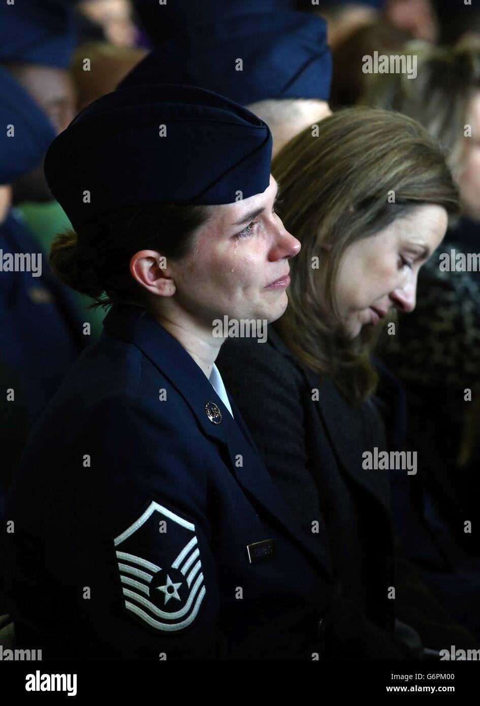 A tear falls down the cheek of a service woman during a memorial ...