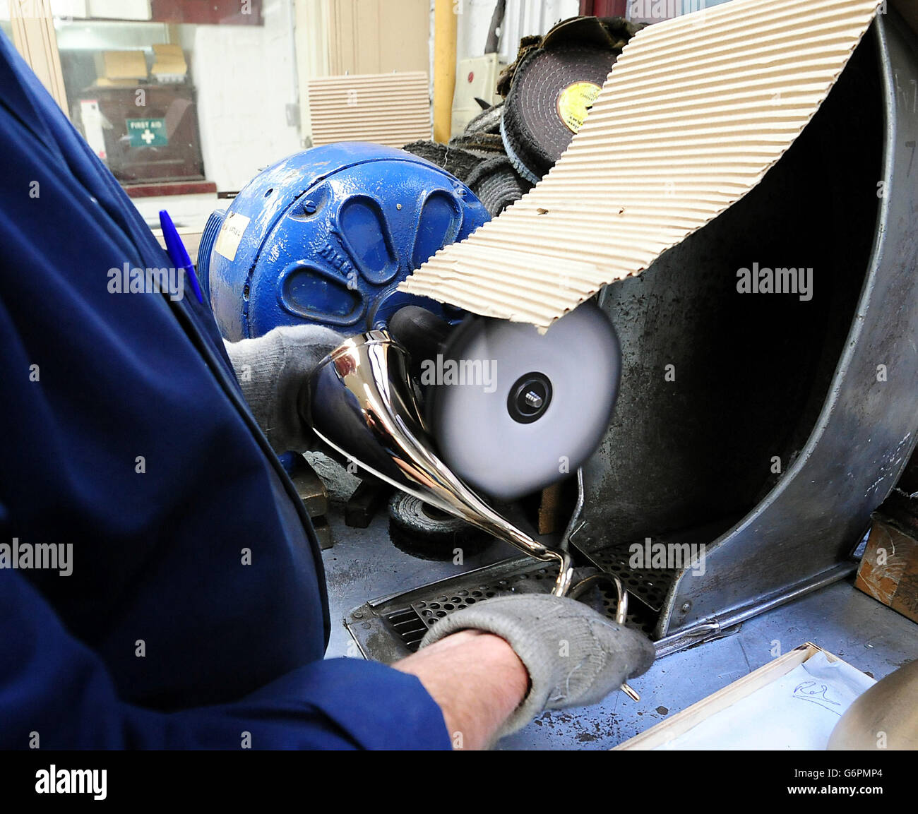 Paul in the finishing department polishes the body of the award, for ...