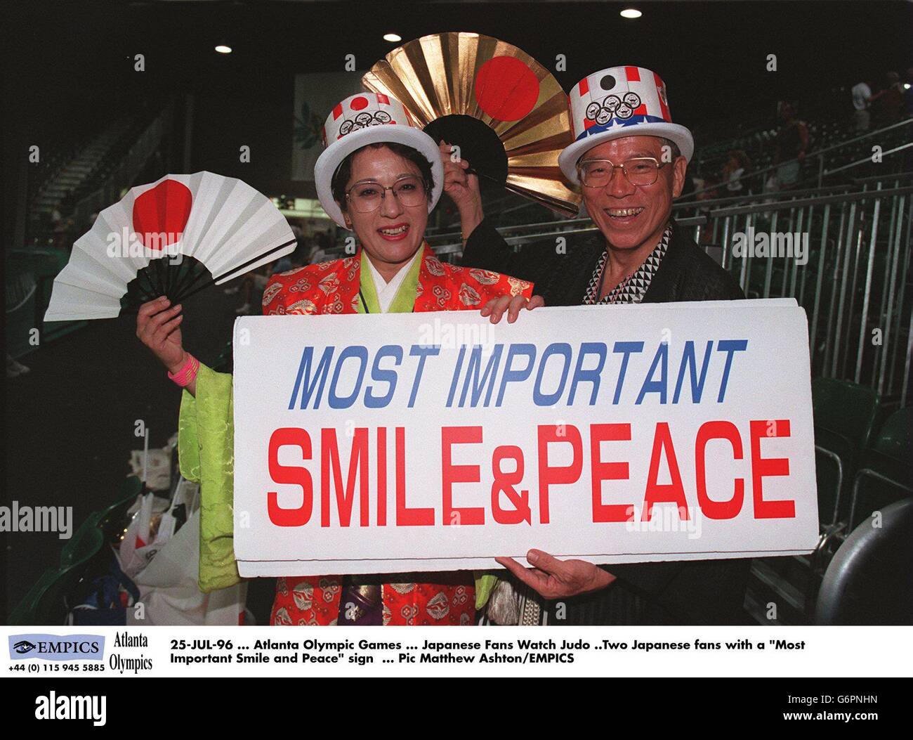 Two Japanese fans convey the spirit of the Olympic Games with a sign ...