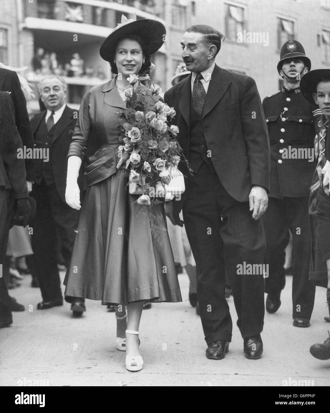 HRH Princess Elizabeth, carrying a bouquet, is welcomed by thousands of ...