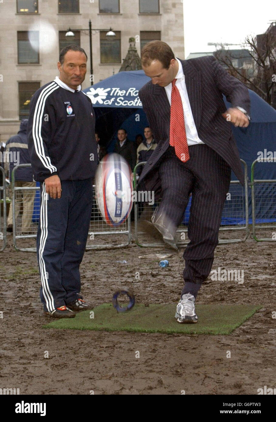 Pin-stripe suited Jonathan Retter takes advice from kicking coach Dave ...