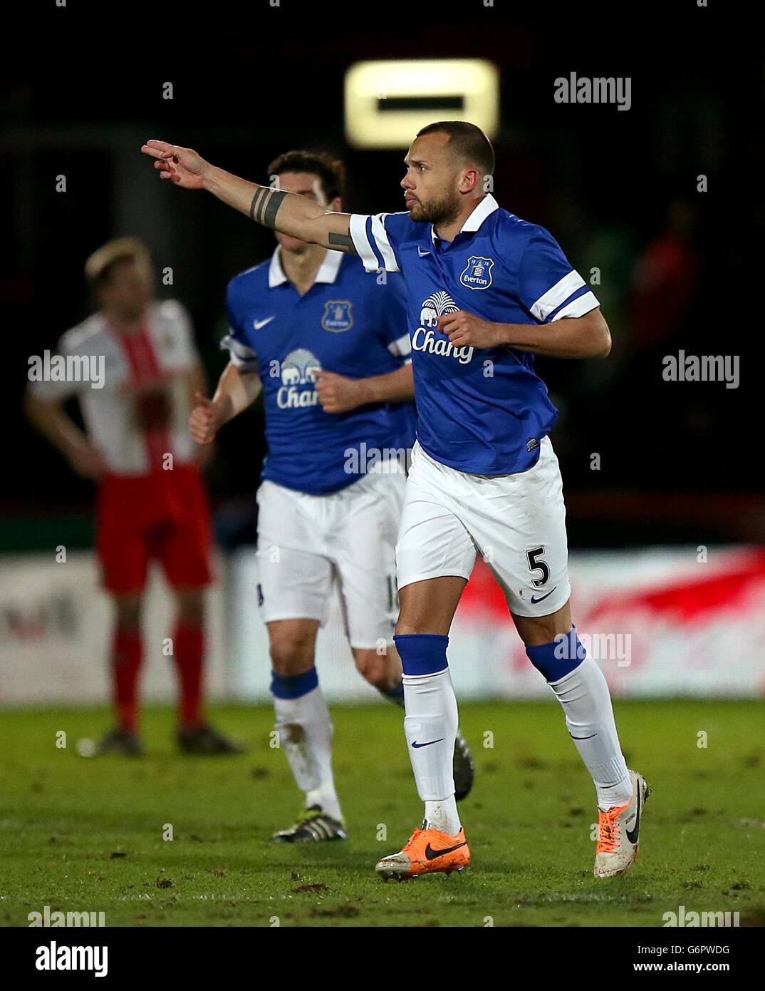 Everton's Johnny Heitinga (5) celebrates after scoring his side's third ...