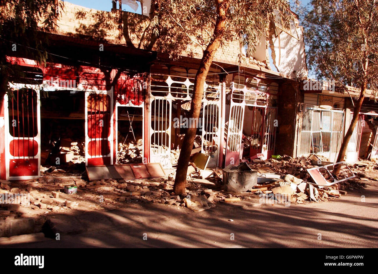 A row of destroyed shops stand empty and abandoned, after being hit by ...