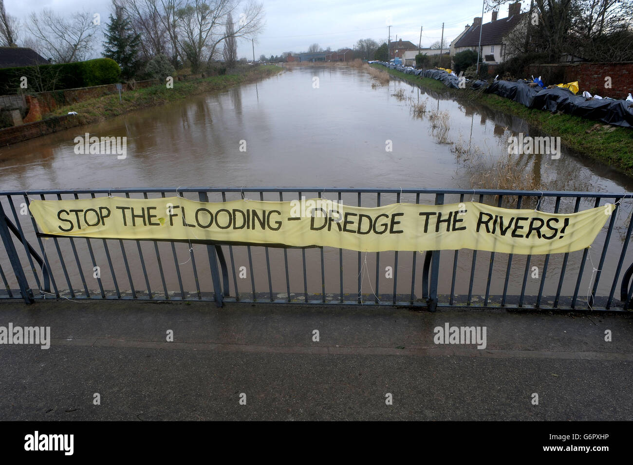 A sign on the bridge over the River Parrett in Burrowbridge as flooding ...