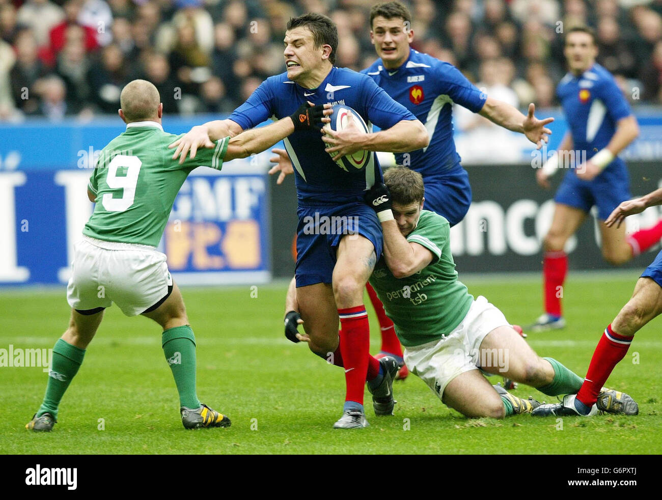 Damien Traille of France (centre) is tackled by Ireland's Peter ...