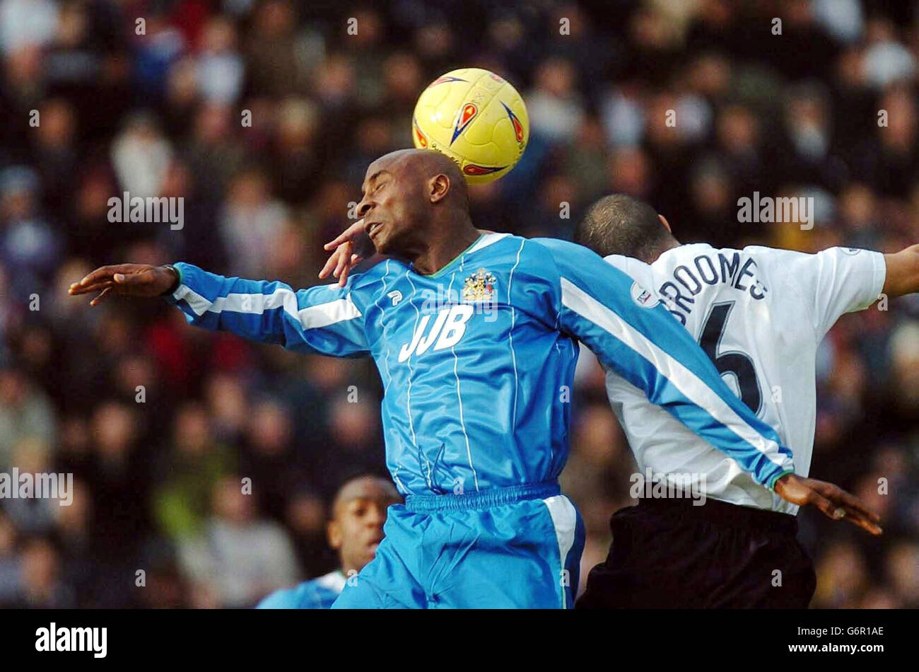 Football header jumping arms raised hi-res stock photography and images ...