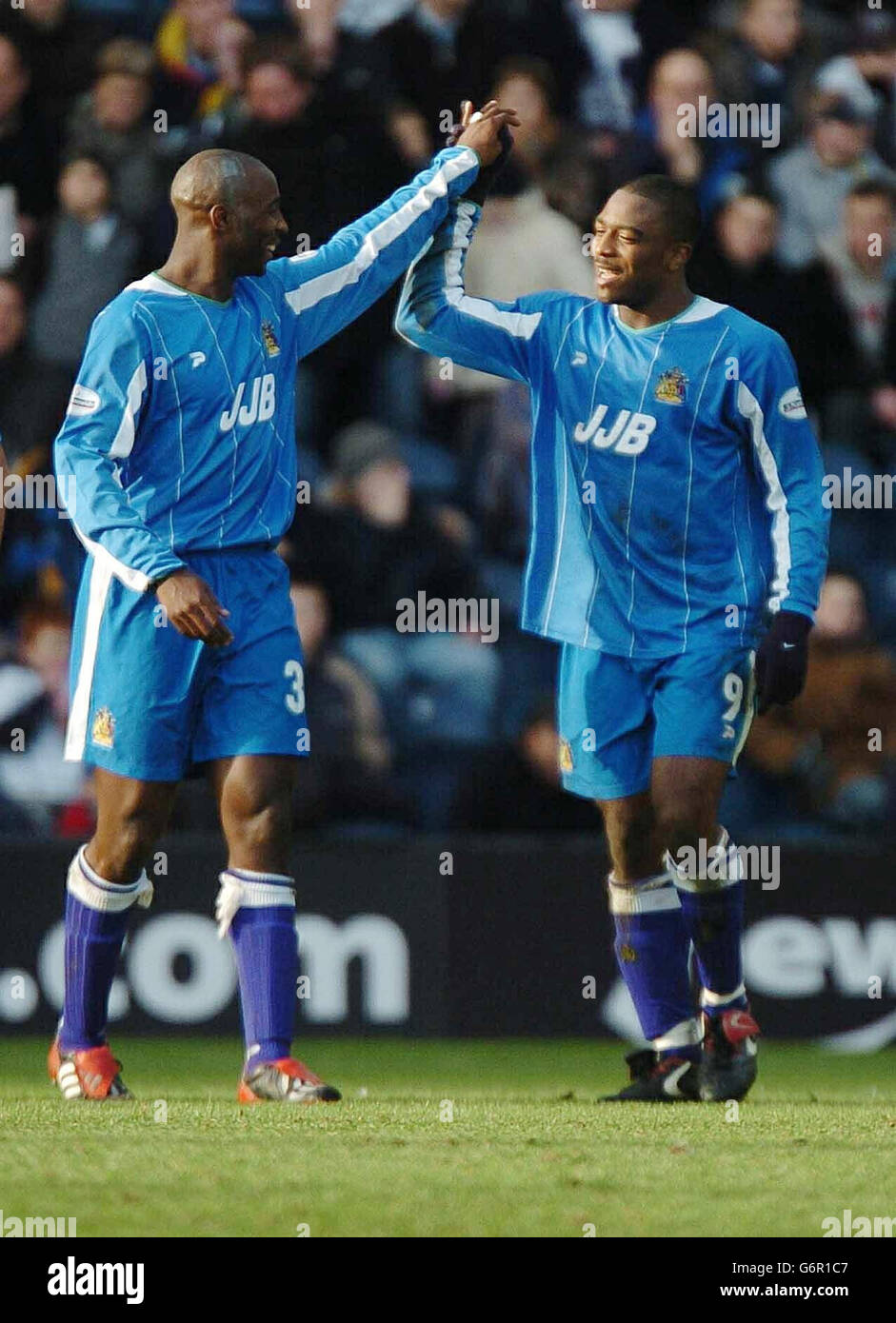 Wigan striker Jason Roberts (left) joins in the celebrations with ...