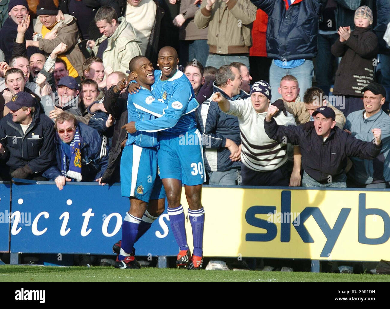 Wigan striker Jason Roberts (right) celebrates scoring in the first ...