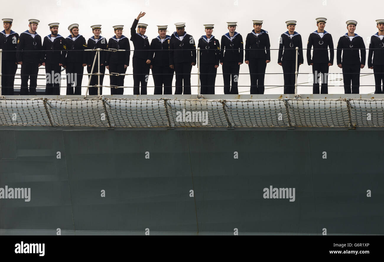 A female rating waves from the flight deck of HMS Illustrious as the ...