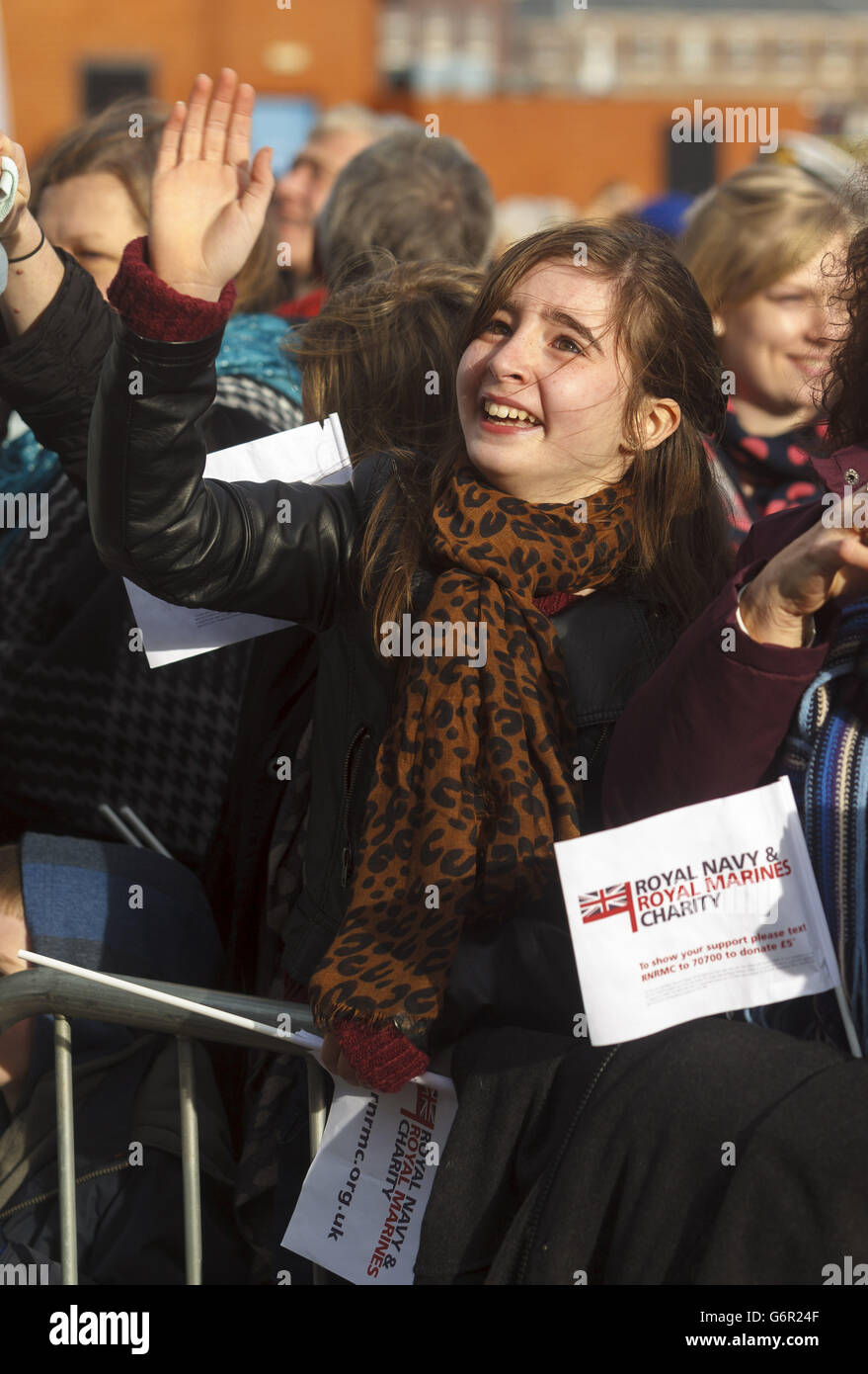 A girl spots her loved one aboard HMS Illustrious as the ship returns ...