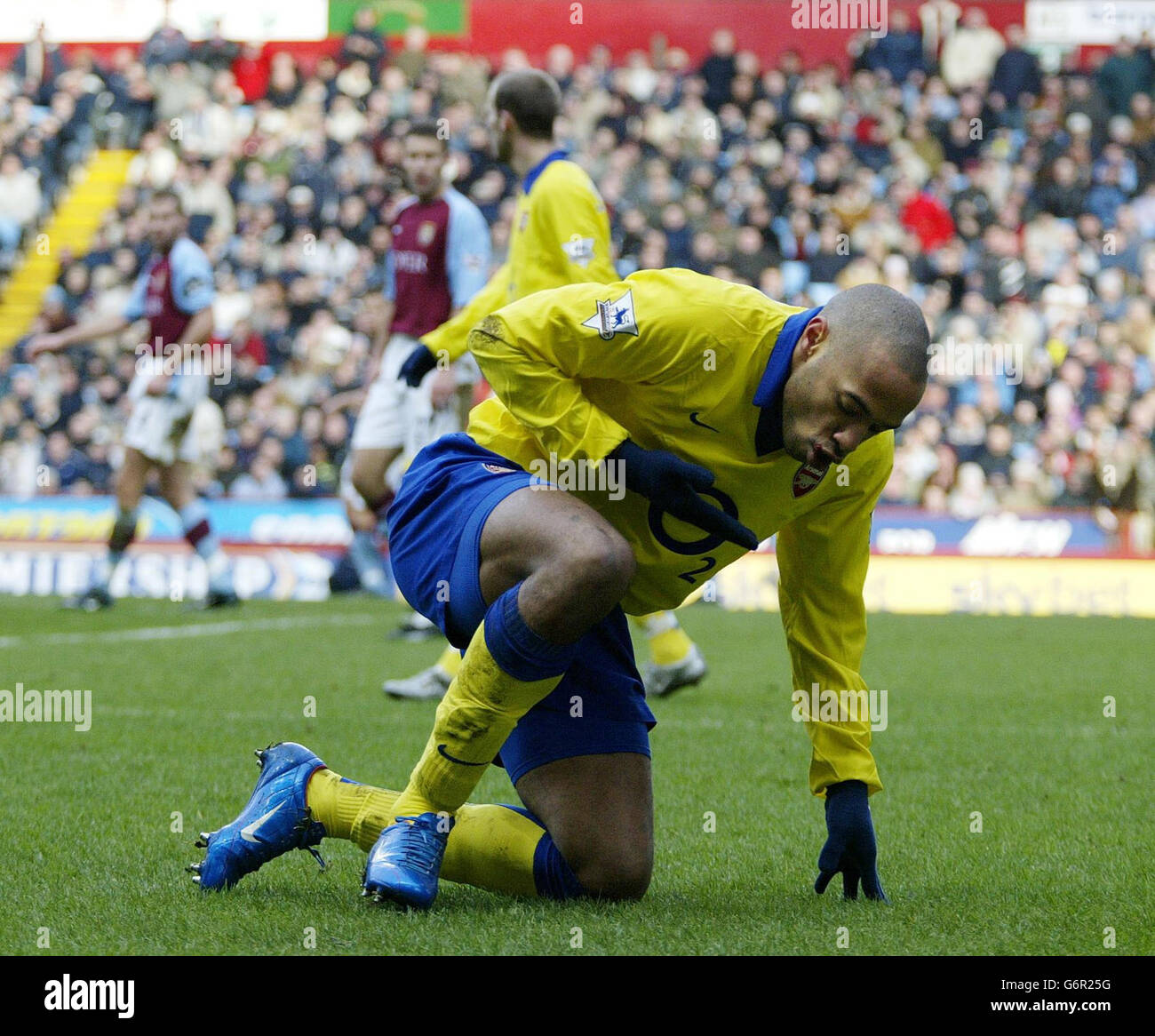 Arsenal's Thierry Henry goes down with cut lip after he was caught by ...