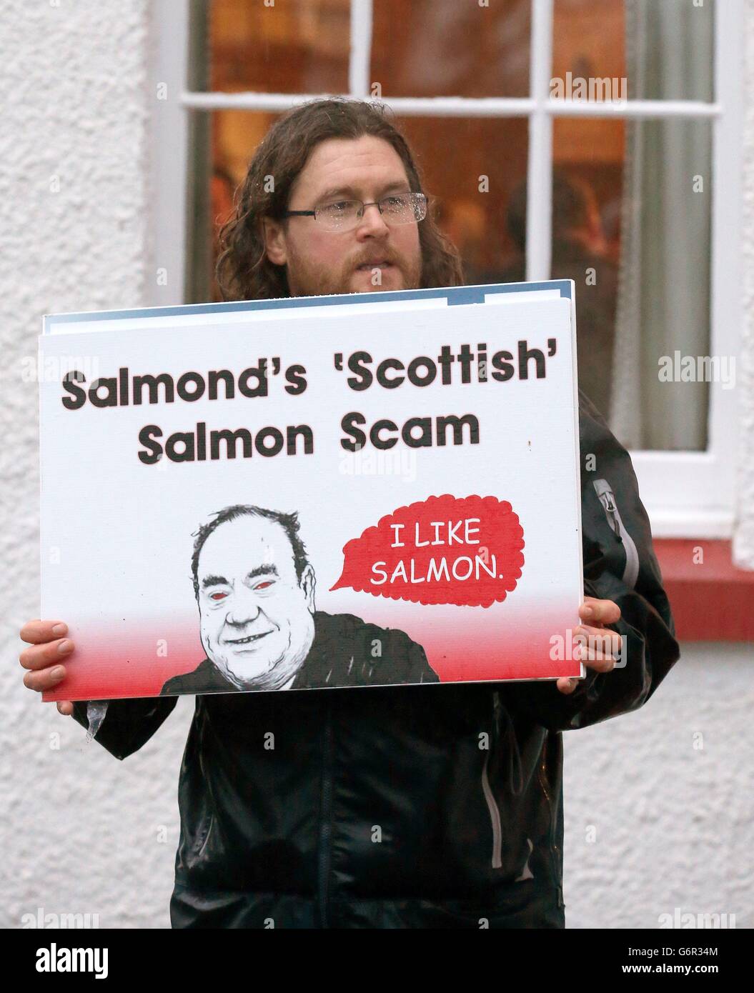 Demonstrators await the arrival of First Minister Alex Salmond at ...