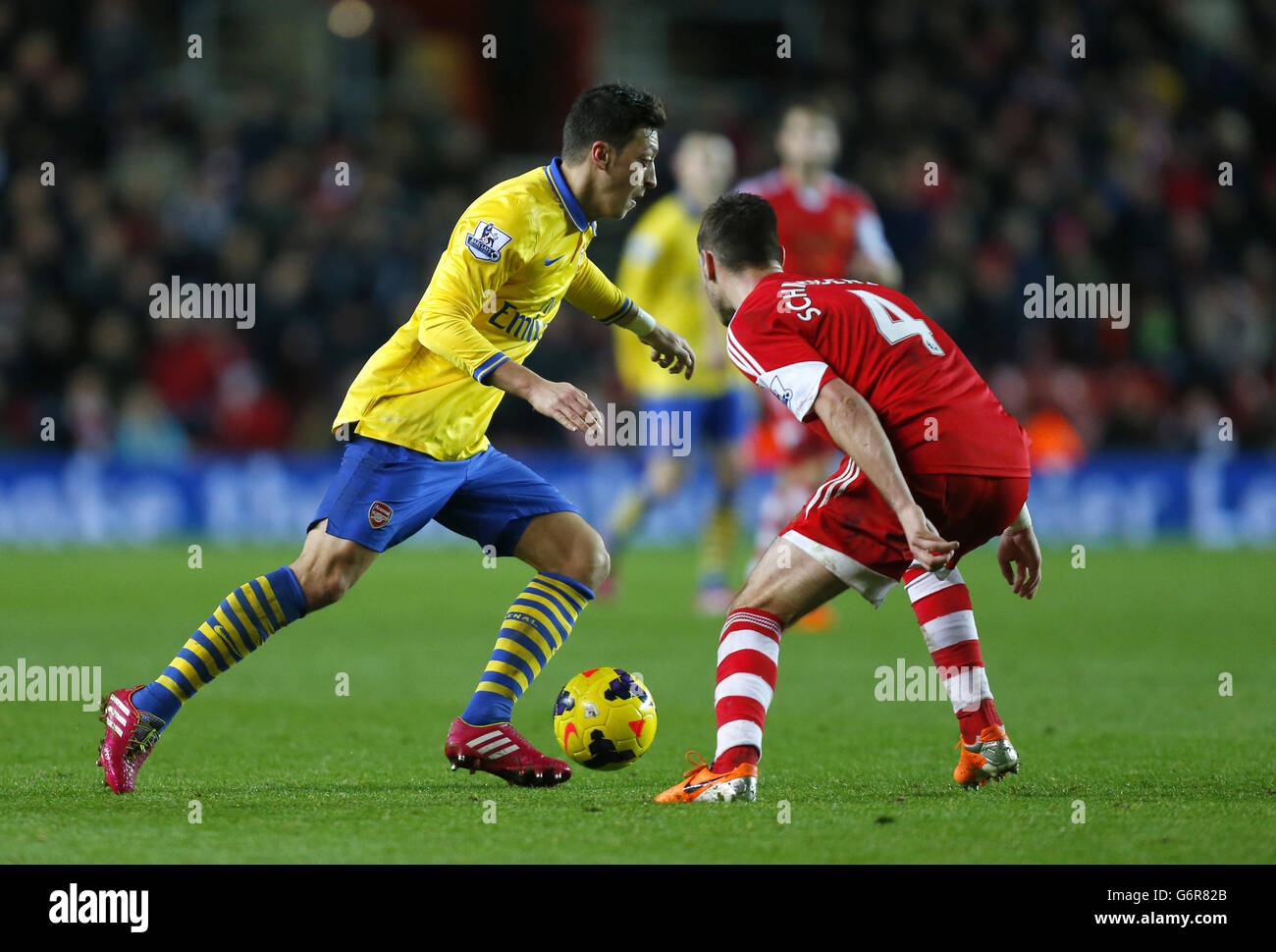 Arsenal's Mesut Ozil (in yellow) in action against Southampton's Morgan ...