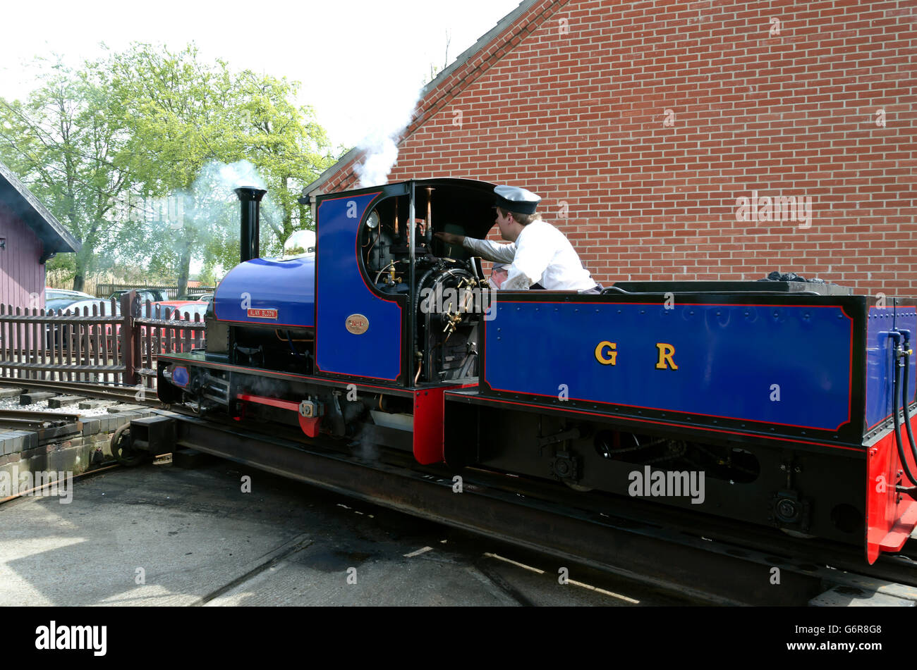 Narrow gauge steam locomotive on a manual turntable at the Bressingham ...