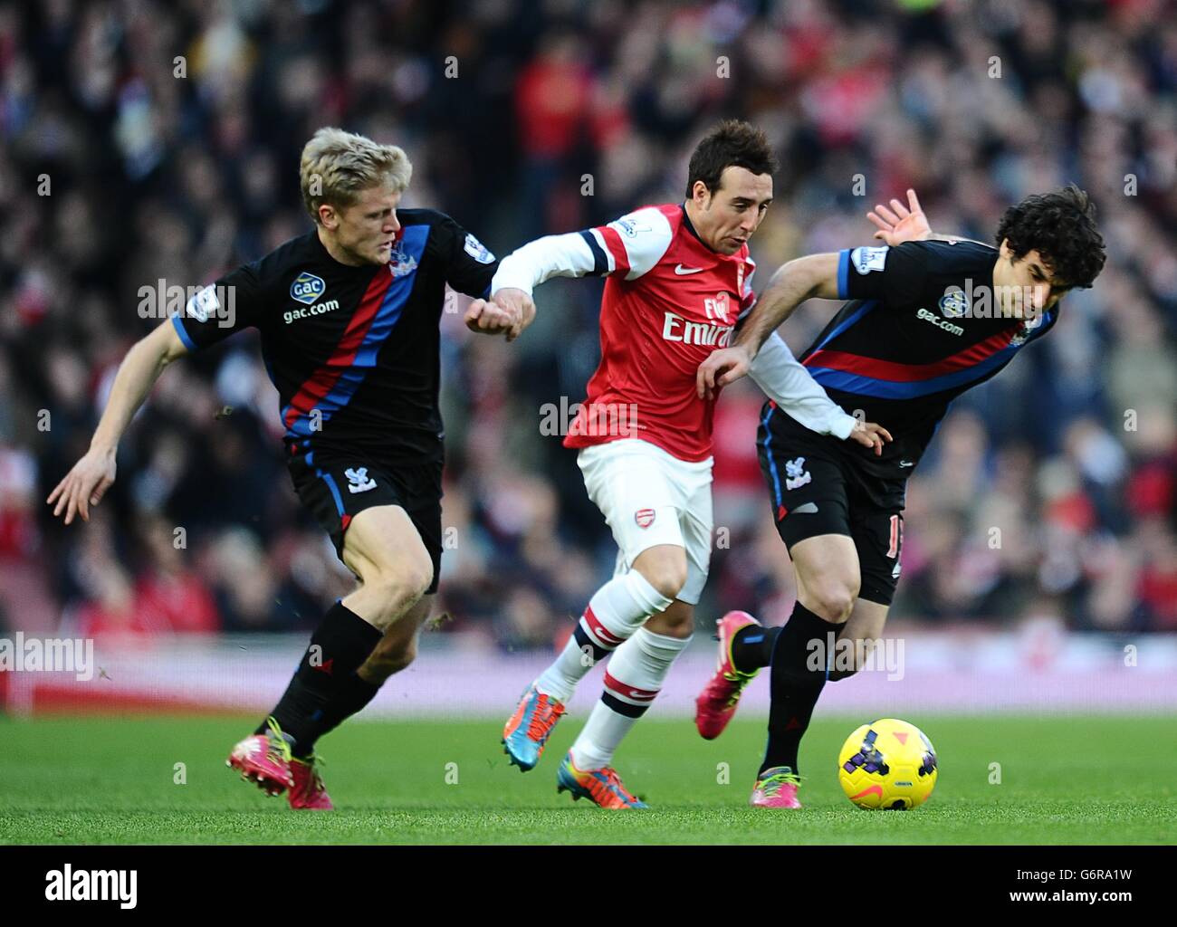 Arsenal's Santi Cazorla (centre) battles for the ball with Crystal ...