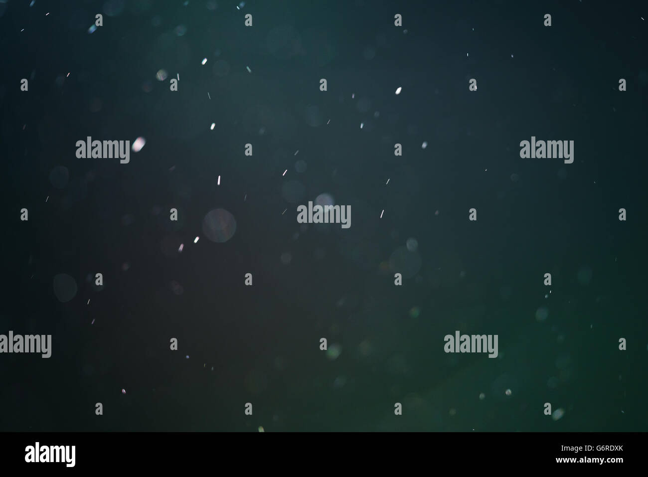 real backlit dust particles with teal toned flare Stock Photo - Alamy