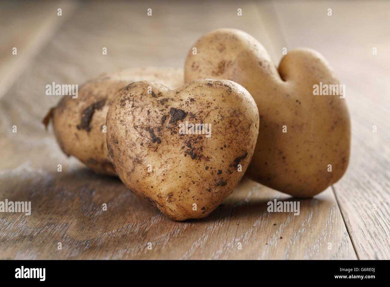 heart shaped potatoes on oak table Stock Photo - Alamy