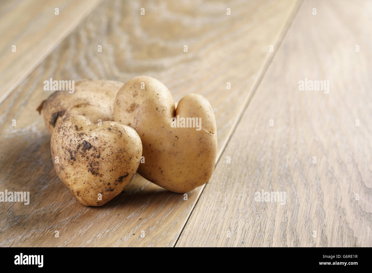 heart shaped potatoes on oak table Stock Photo - Alamy