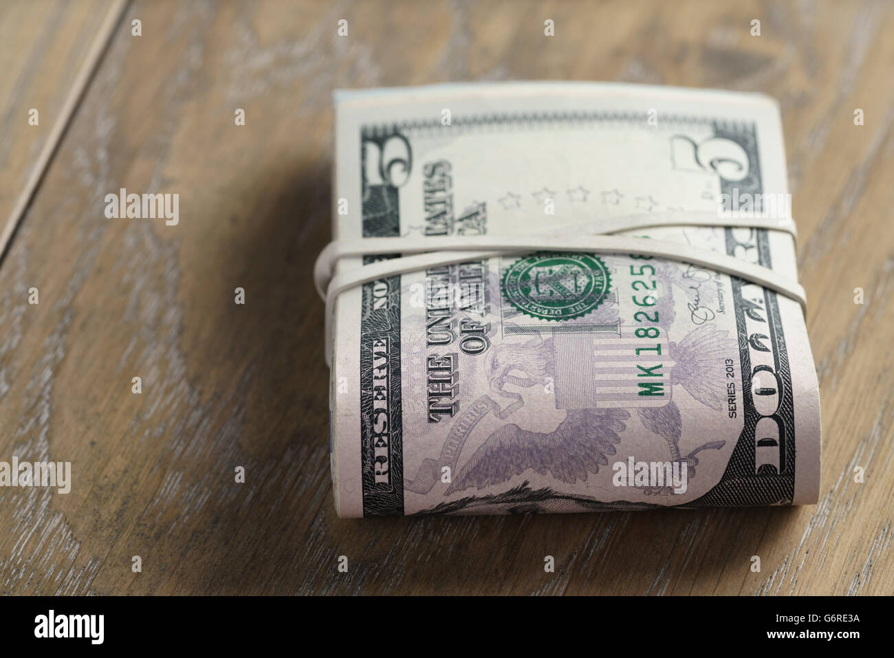bunch of dollars on oak wood table Stock Photo - Alamy