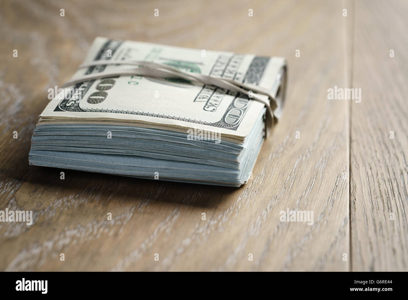 bunch of dollars on oak wood table Stock Photo - Alamy