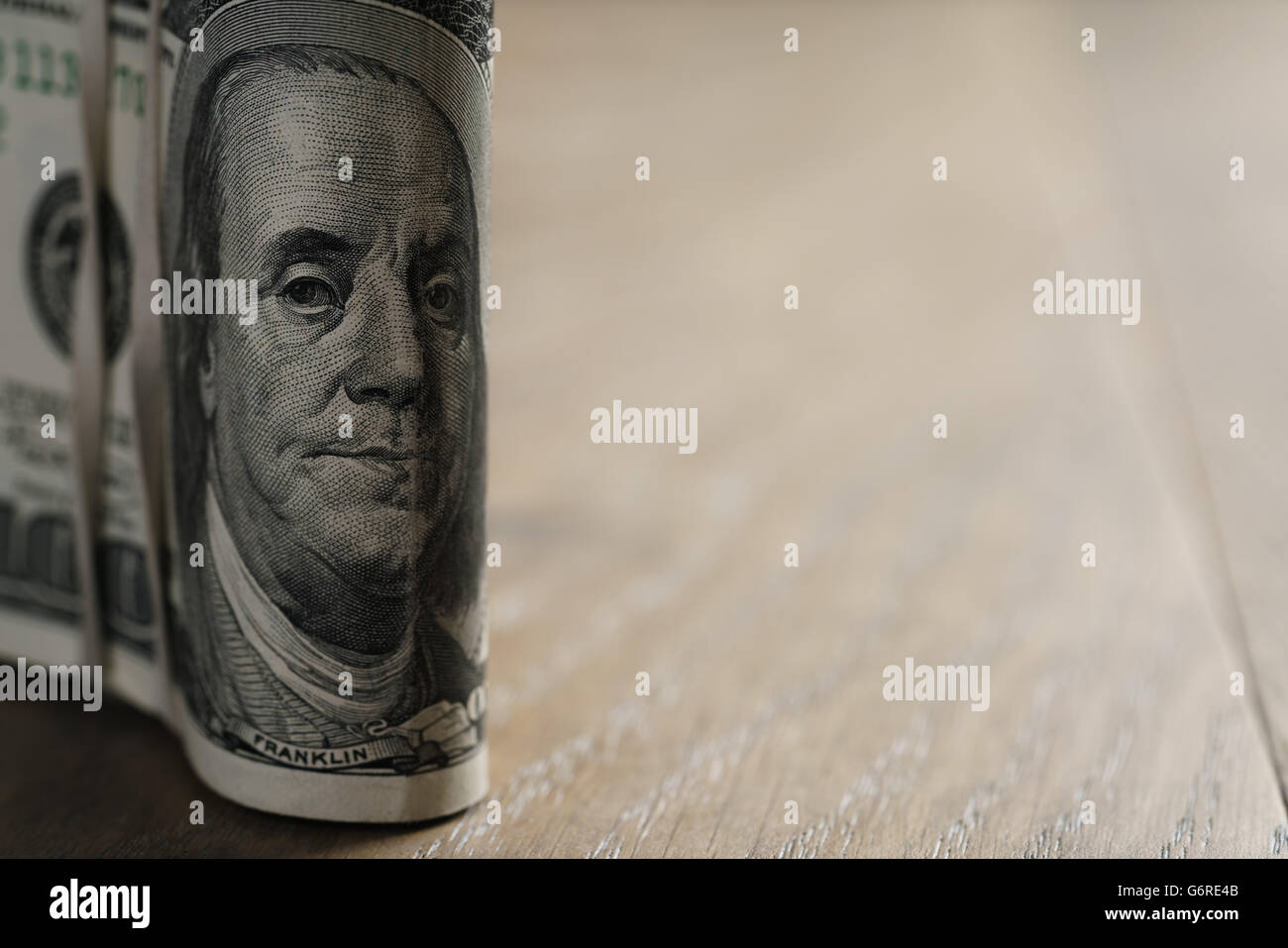 bunch of dollars on oak wood table Stock Photo - Alamy