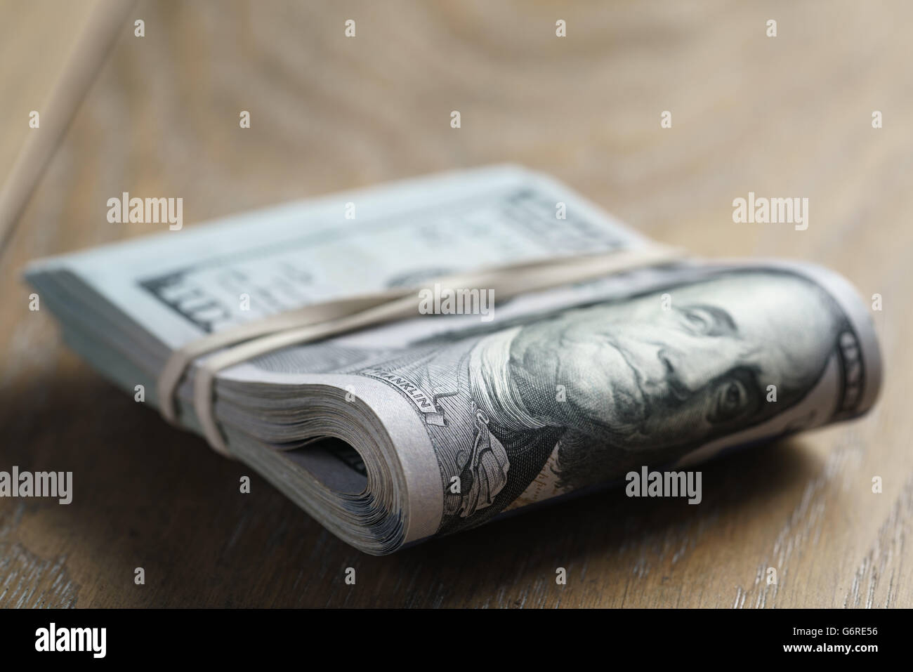 bunch of dollars on oak wood table Stock Photo - Alamy