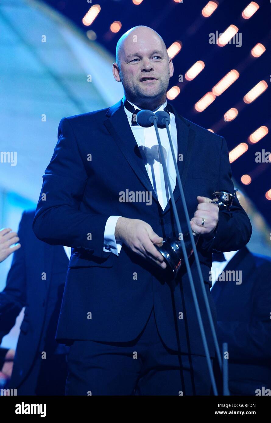 Jonny Mitchell collecting the best documentary series award on stage ...