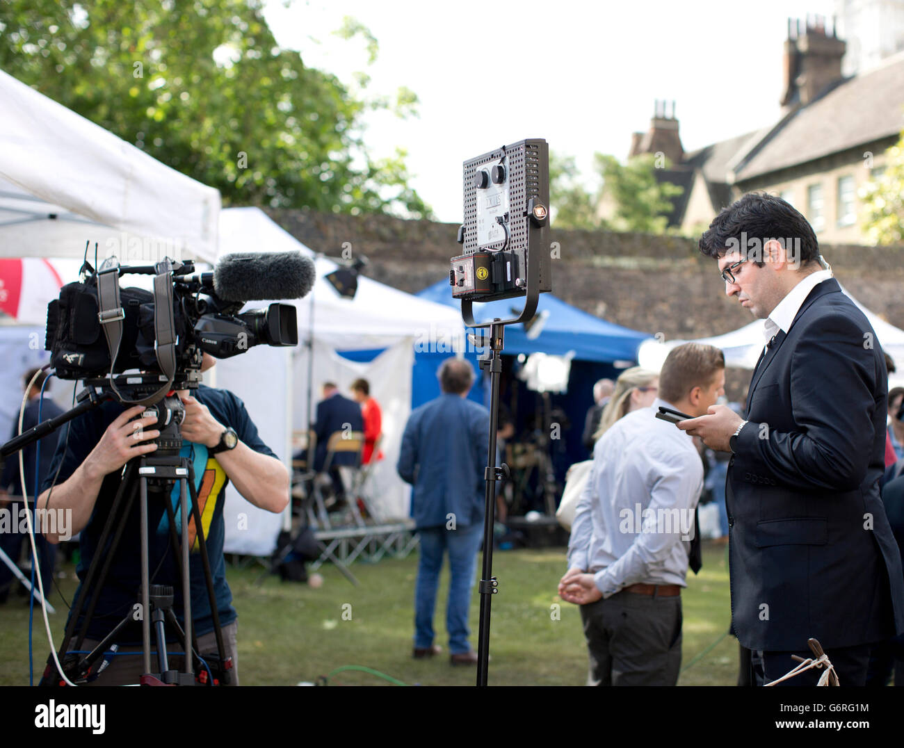 A reporter prepares to speak to camera at College Green in Westminster ...