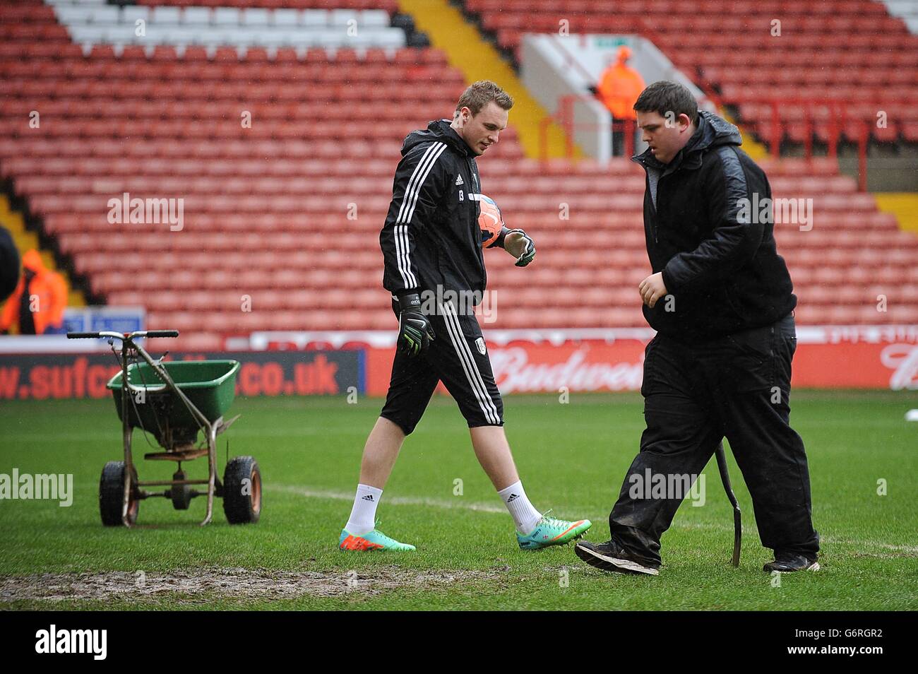 Fulham goalkeeper david stockdale out muddy pitch during the warm up hi ...