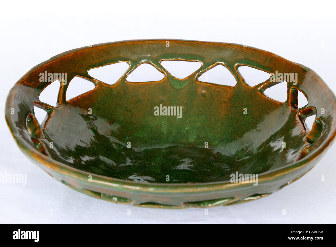 Ceramic pot pottery green glazed dish with cut out design round the ...