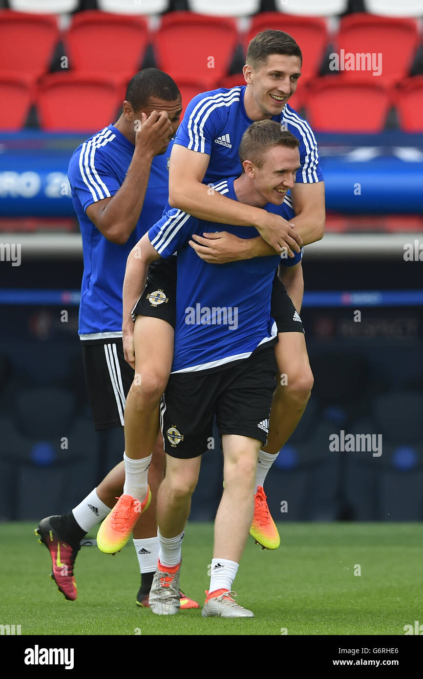 Northern Ireland's Shane Ferguson gives a piggyback to Craig Cathcart ...