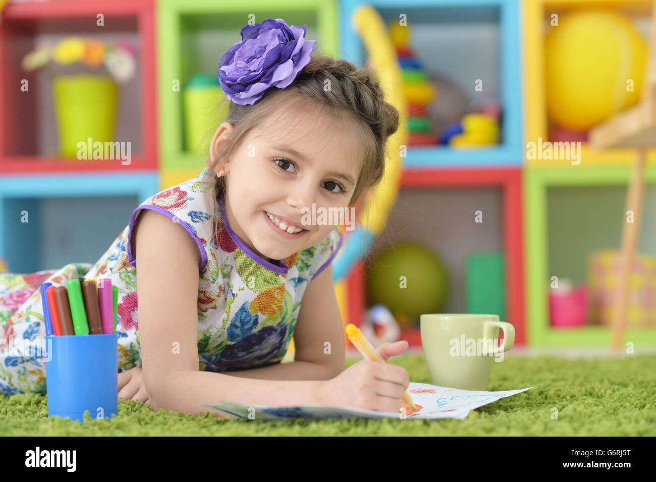 Little girl drawing at class Stock Photo - Alamy