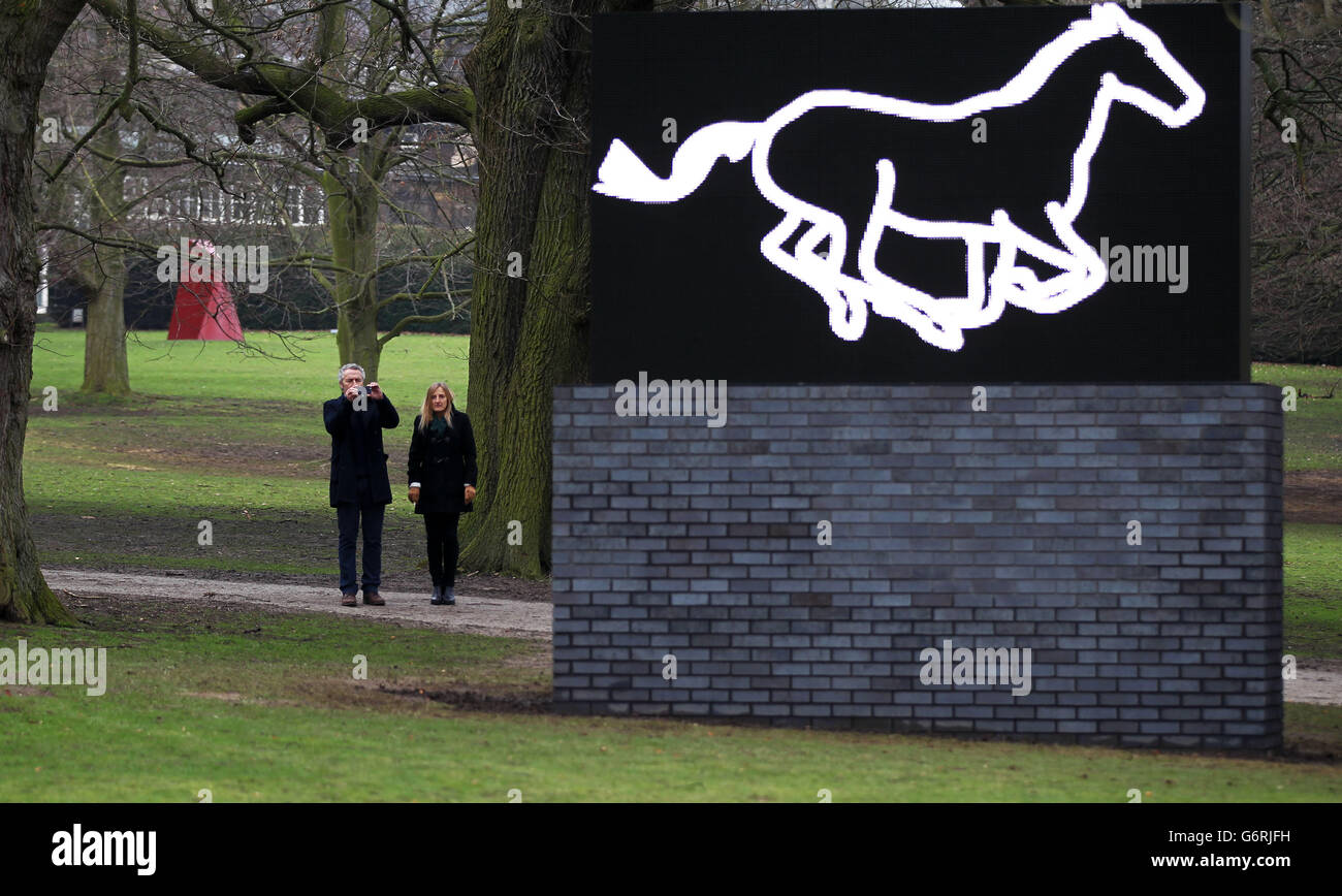 Artist Julian Opie and his wife Aniela photograph his LED sculpture ...