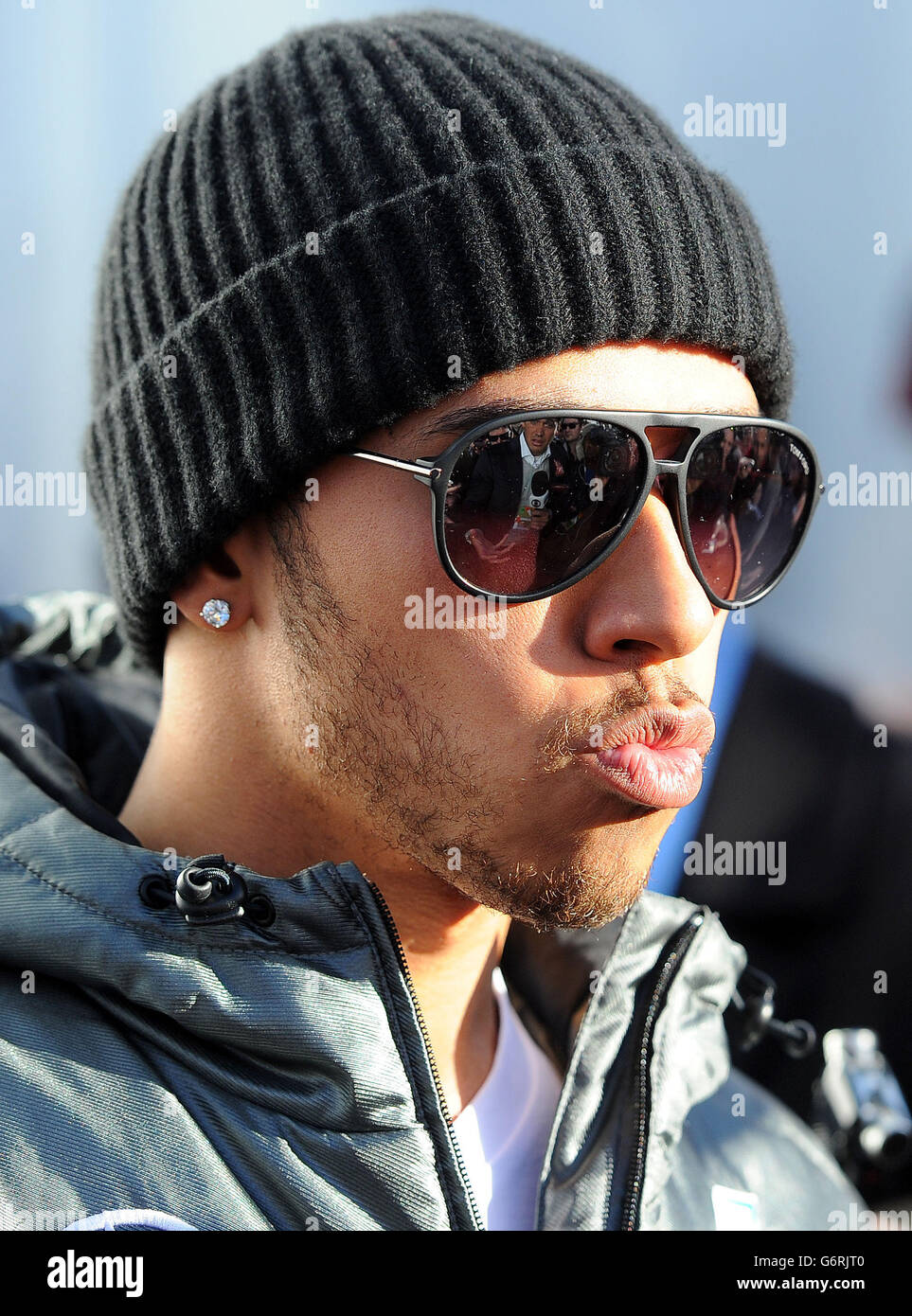 Mercedes driver Lewis Hamilton speaks outside the team garage, during ...