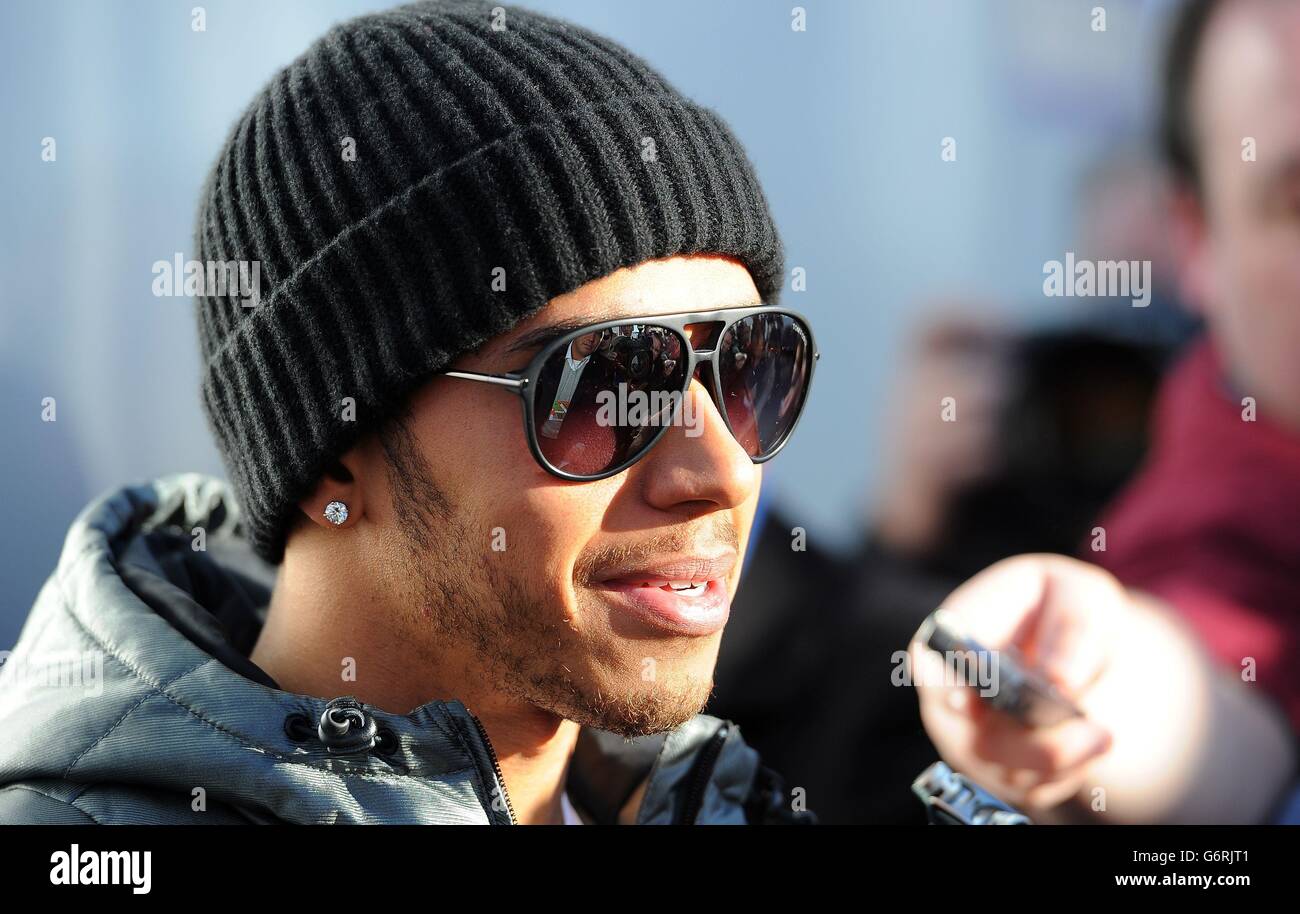 Mercedes driver Lewis Hamilton speaks outside the team garage, during ...