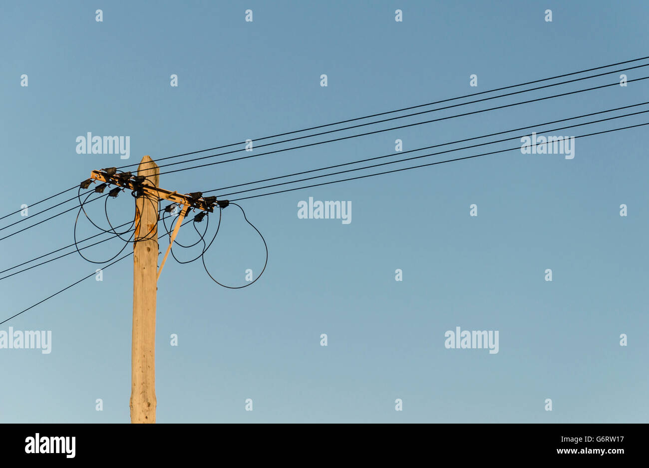 view of the head of an old-fashioned electric pole with wires and ...