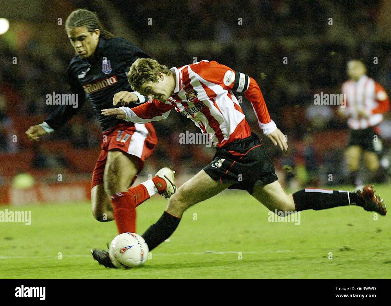 Sunderland's George Mc Cartney (left) battles with Stoke city's Darel ...