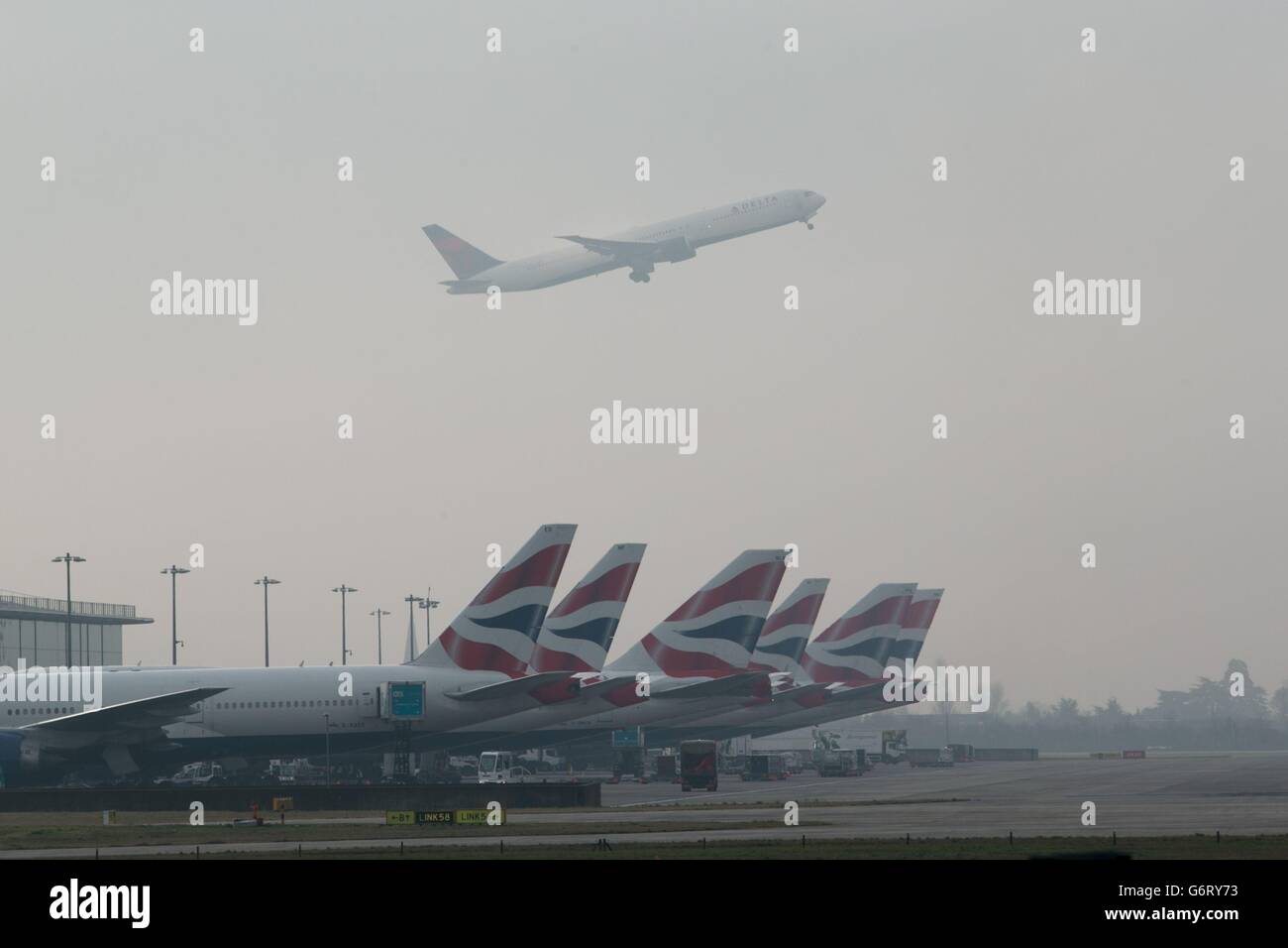 Planes take off in light fog at Heathrow Airport in London Stock Photo ...