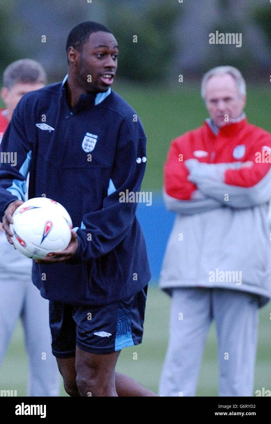 England football coach Sven-Goran Eriksson (background) keeps a ...