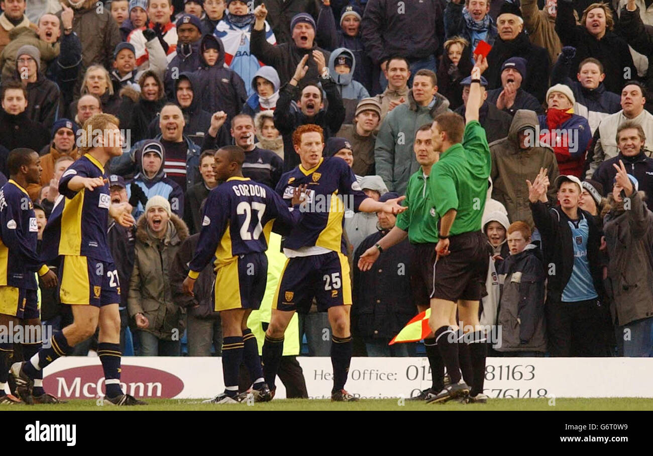 Referee Steve Tanner shows Wimbledon's Dean Lewington a red card during ...
