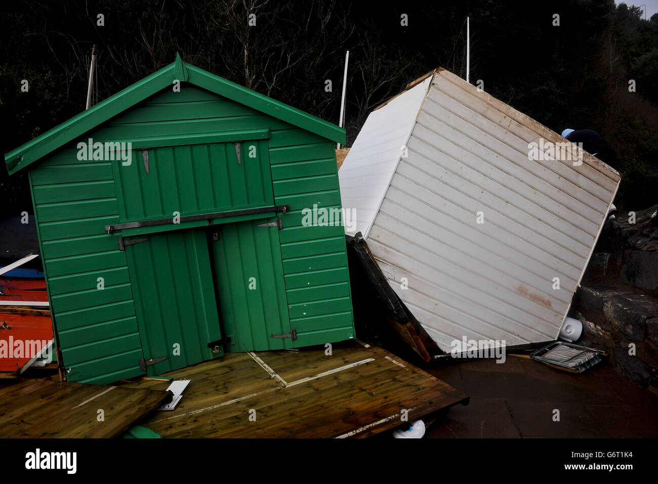 Beach huts that were once standing on the sea wall are now wrecked and ...