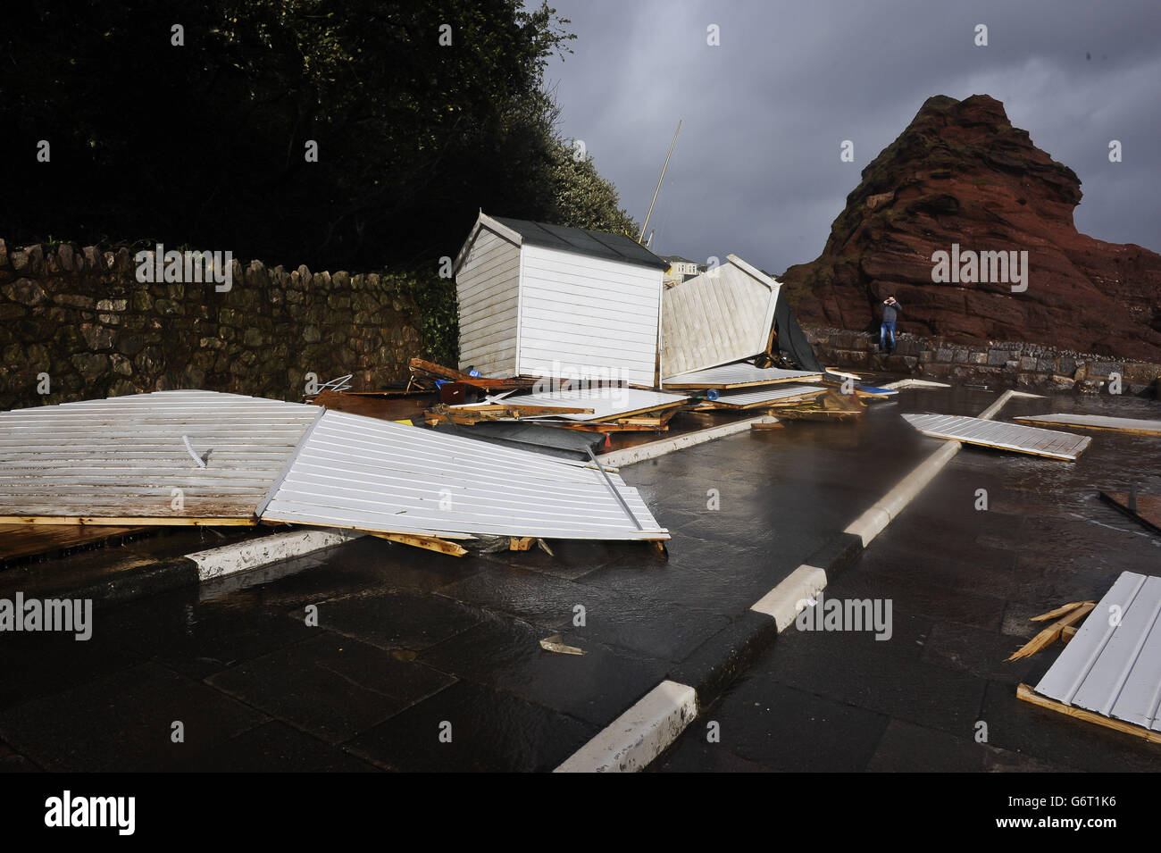 Beach huts that were once standing on the sea wall are now wrecked and ...