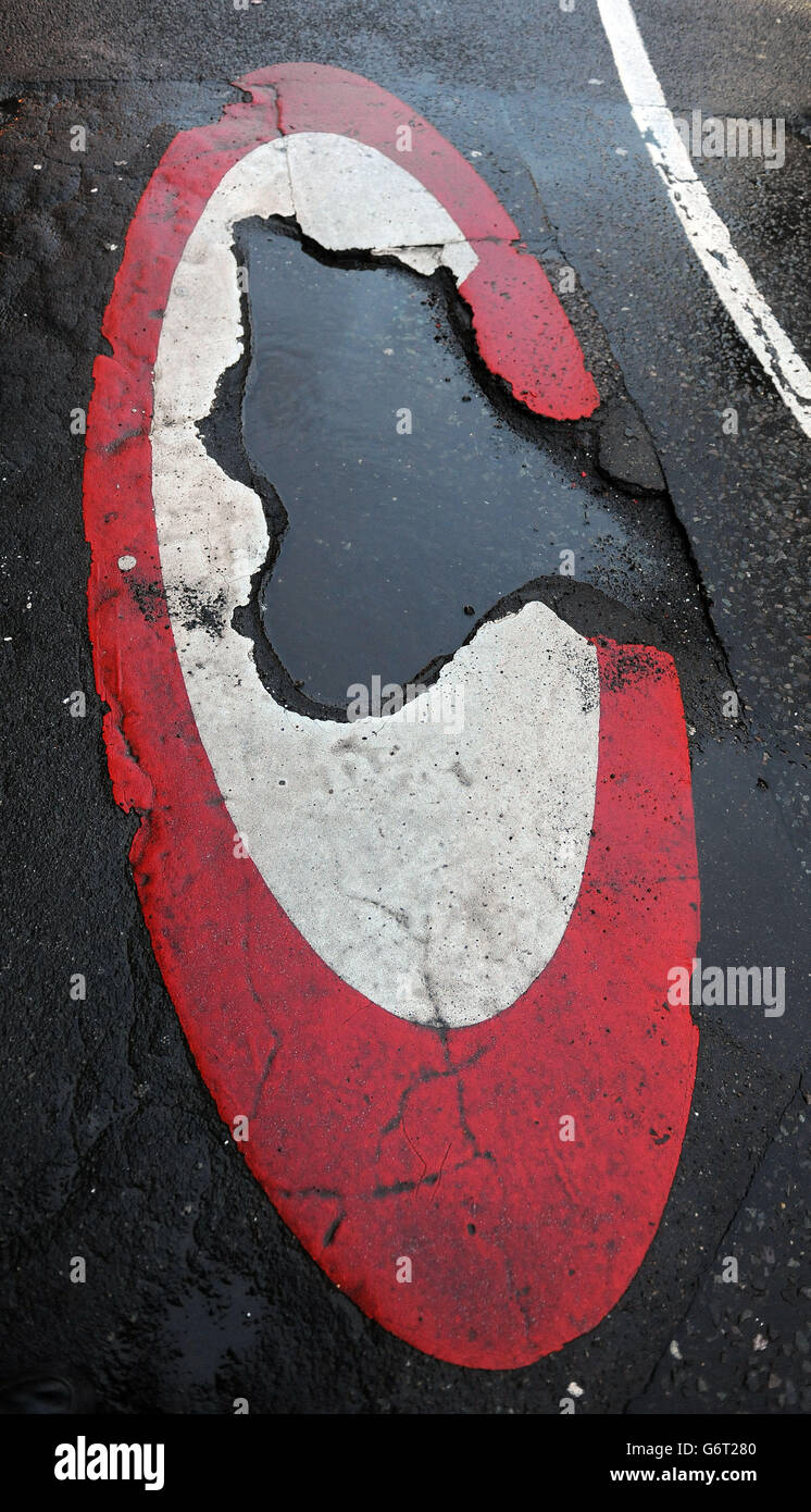 A pothole inside a congestion charge road marking hi-res stock ...