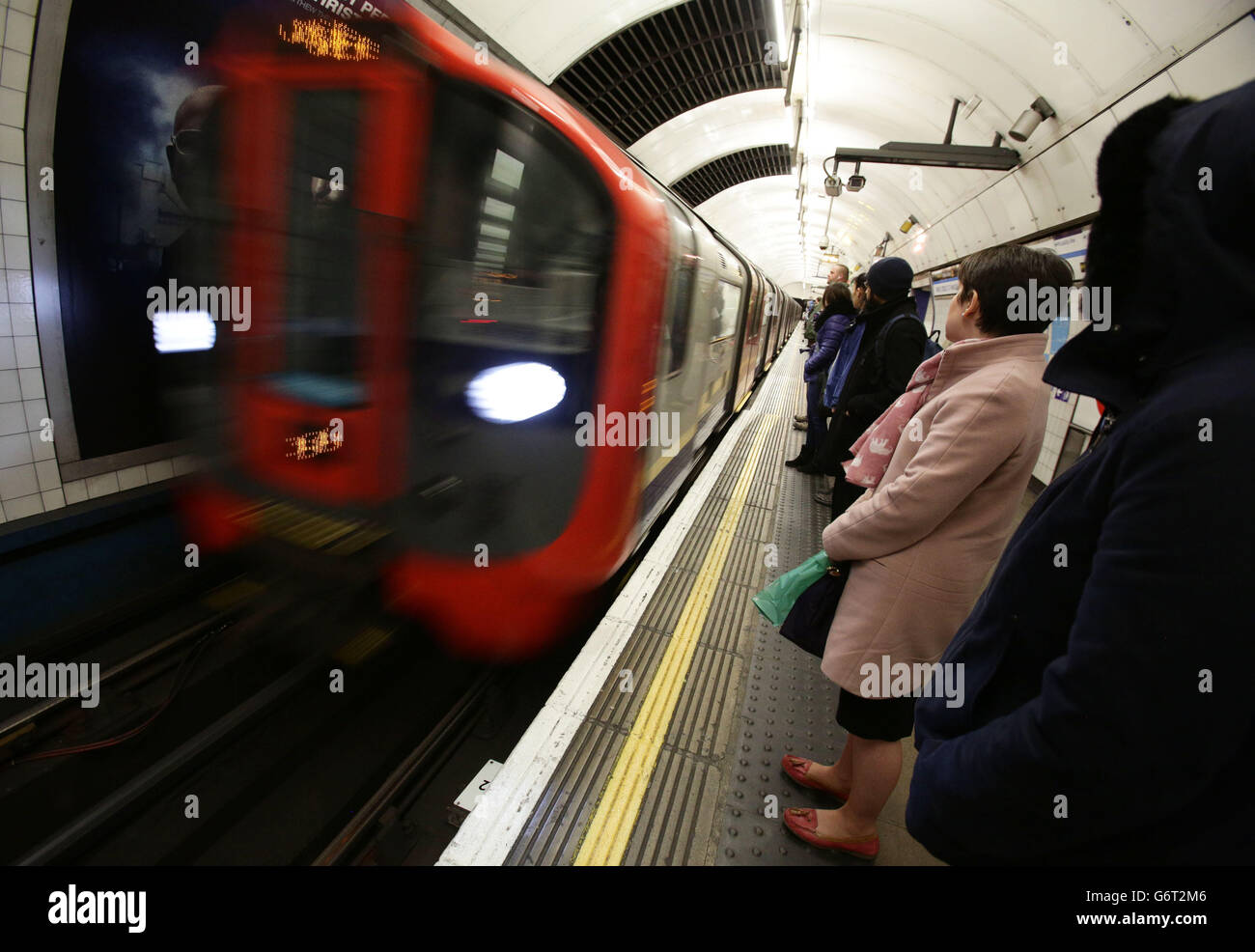 Commuters on the Victoria Line platform at King's Cross station during ...