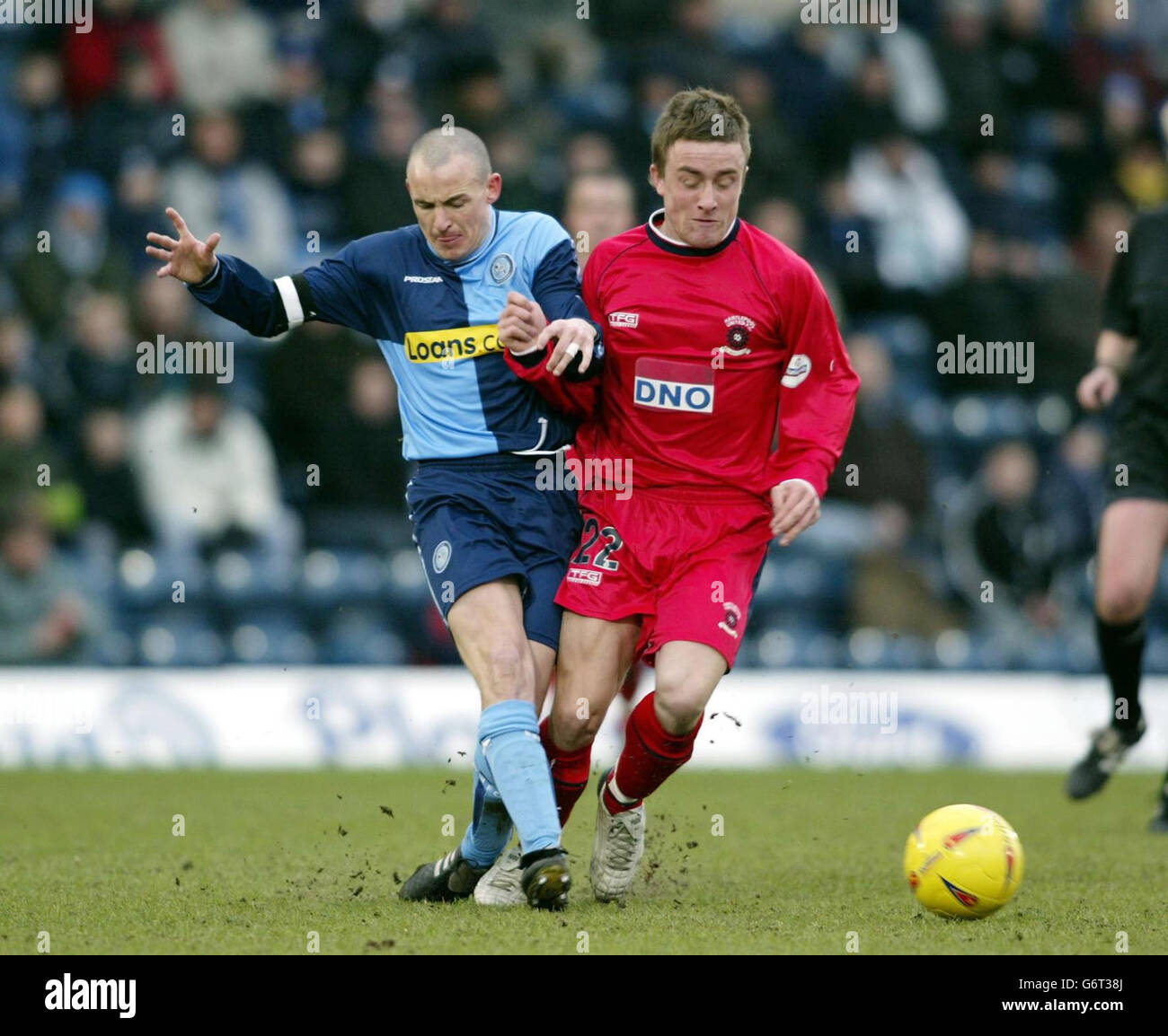 Wycombe's Michael Simpson (left) tackles Hartlepool's Matty Robson ...