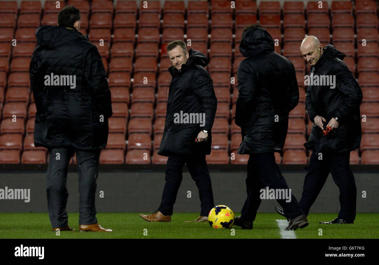Referee Jonathan Moss (2nd left) during a pitch inspection due to the ...