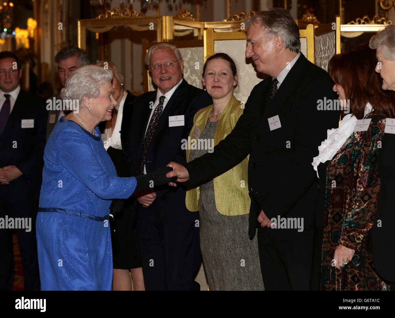 Queen Elizabeth II meeting guests, including Alan Rickman, during a ...